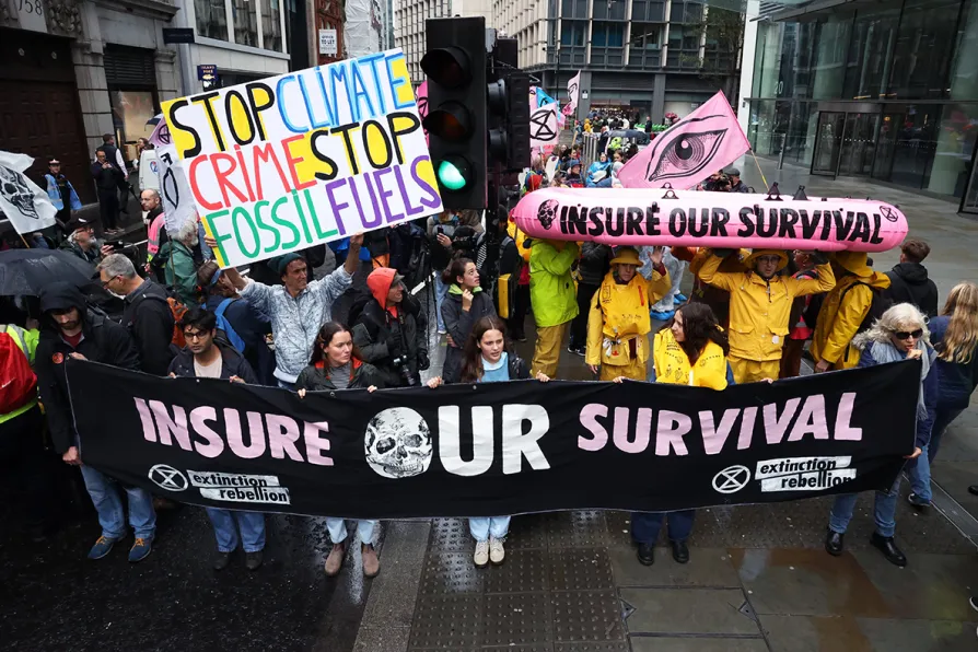 XR activists occupy the Gherkin as they continue week of action against ...